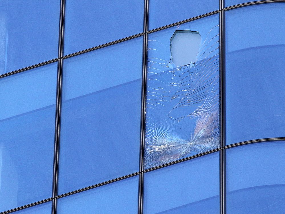 Glass falls 33 storeys from downtown building, lands on moving vehicle ...