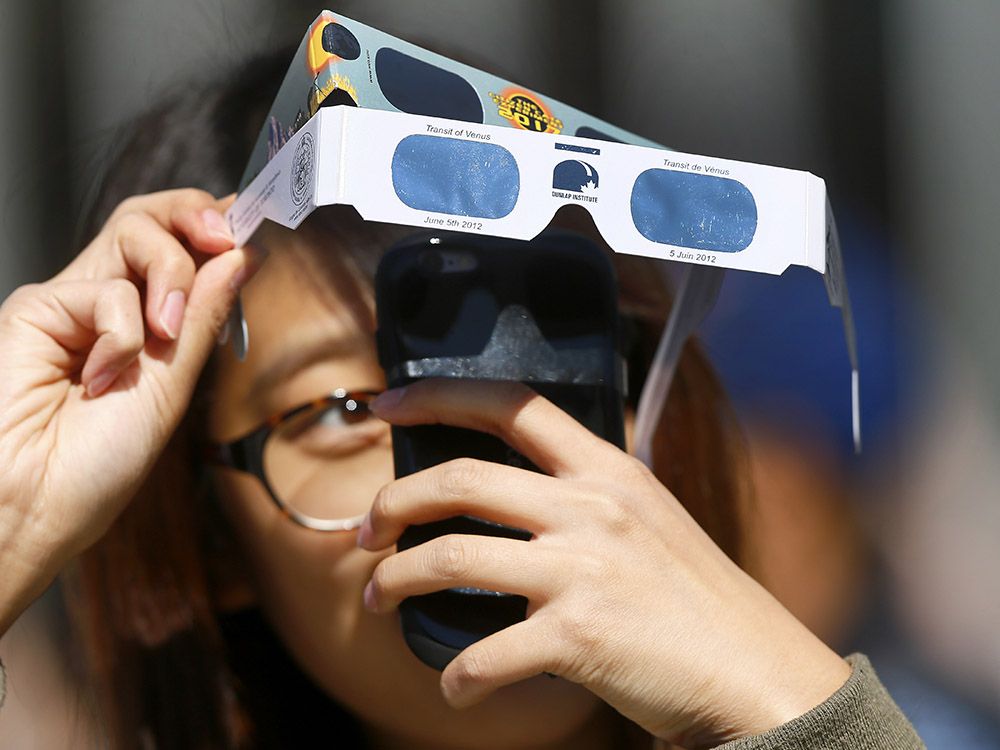 Calgary skywatchers of all ages gather to view rare solar eclipse ...