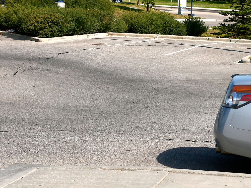 Depression in pavement strands three vehicles at CTrain parking lot ...
