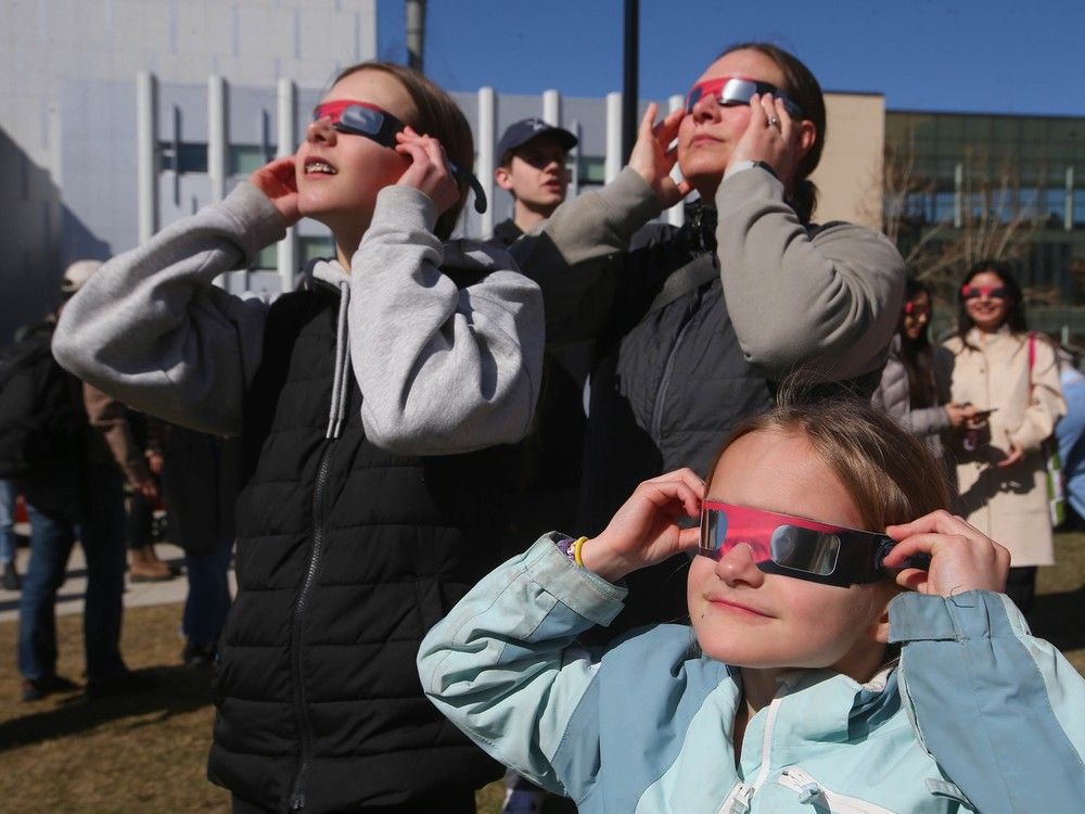 Calgarians bask in partial solar eclipse at viewings across the city ...