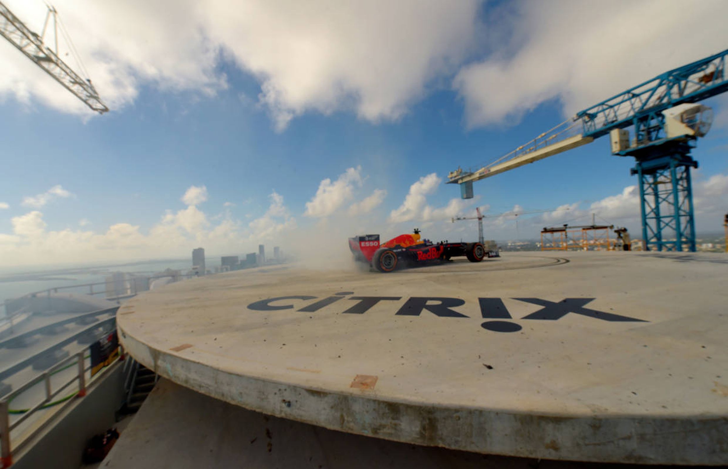 F1 car pulls doughnuts on top of a Miami skyscraper | Driving