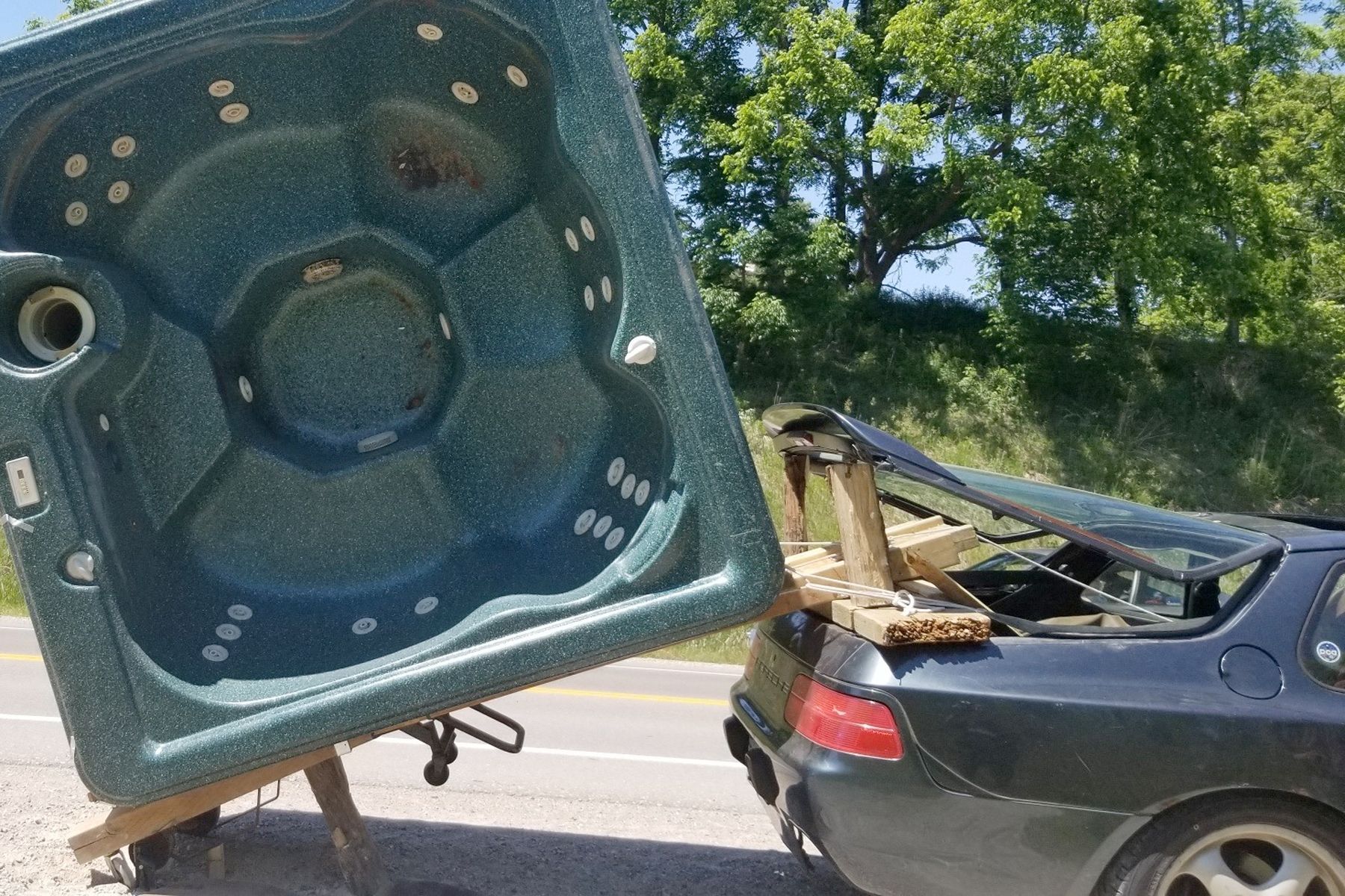 Shame! Porsche driver busted towing hot tub on slapdash wooden cart ...