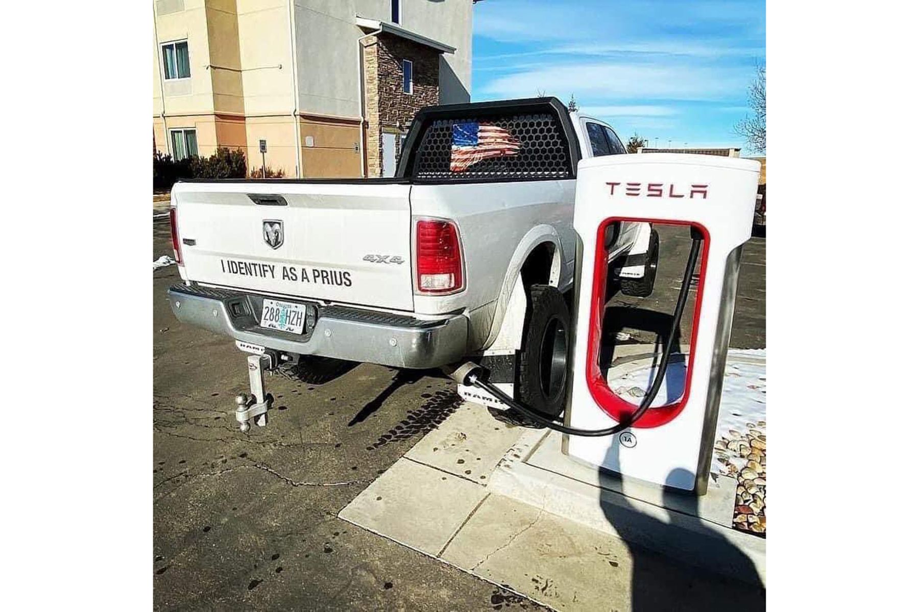 Ram with Tesla charger in tailpipe shows 'ICE-ing' trend not over | Driving