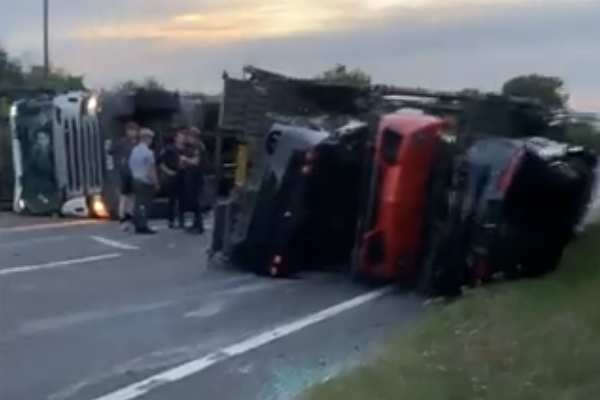 Transport truck carrying supercars topples over in U.K. | Driving