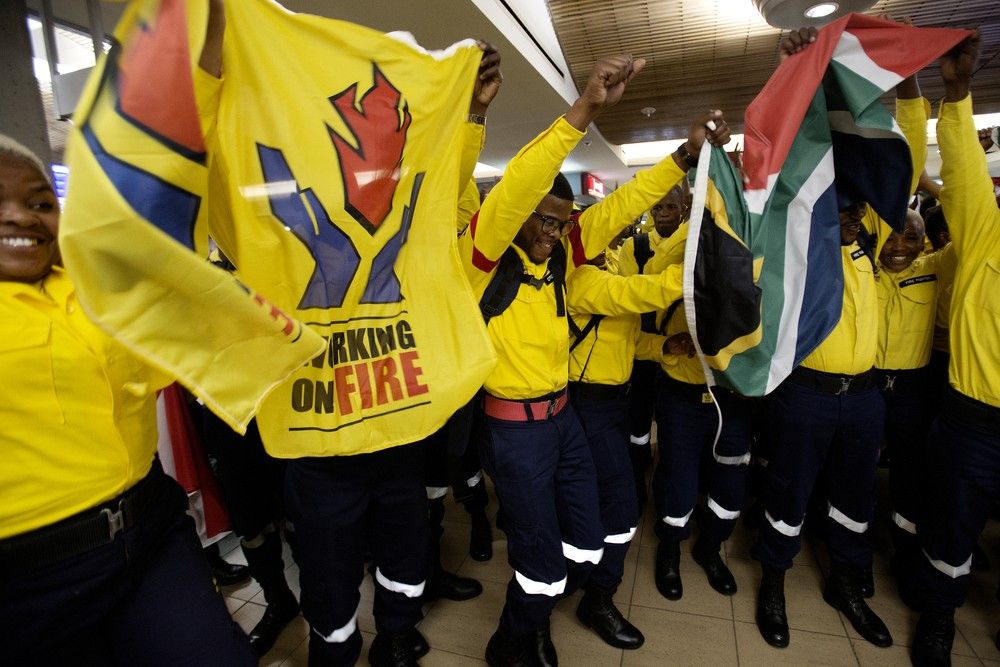 Photos: South African firefighters arrive at Edmonton International ...