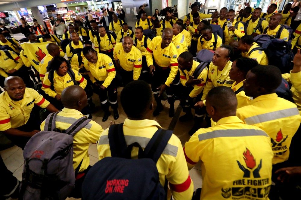 Photos: South African firefighters arrive at Edmonton International ...