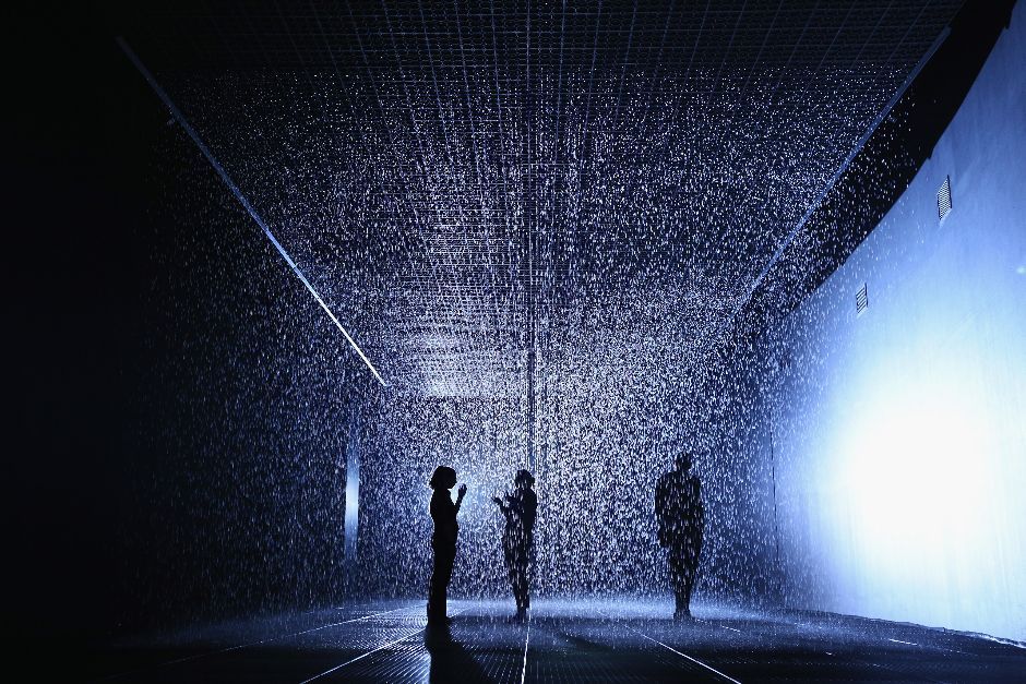 Visitors 'part the rain' in a surreal experience at the 'Rain Room ...