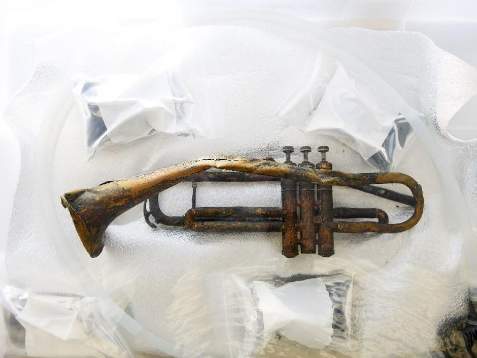 A broken trumpet from a sunken American warship holds its secrets from ...