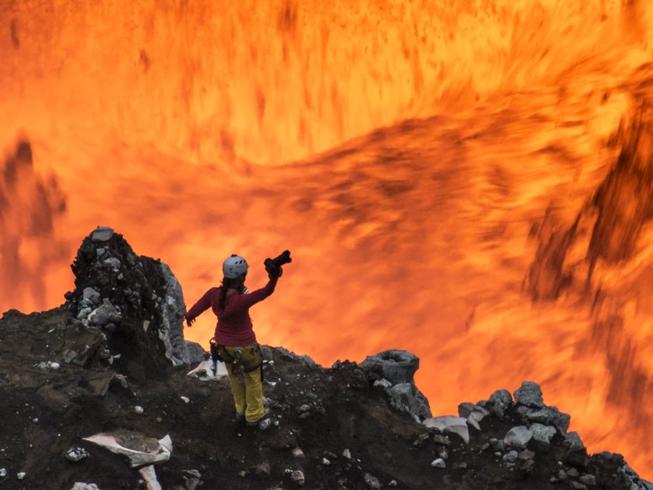Yes, this is a real photo of a woman on the edge of a volcano. Read the ...