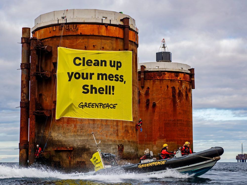 'Clean up your mess, Shell!' Climate activists scale ocean oil rig in ...