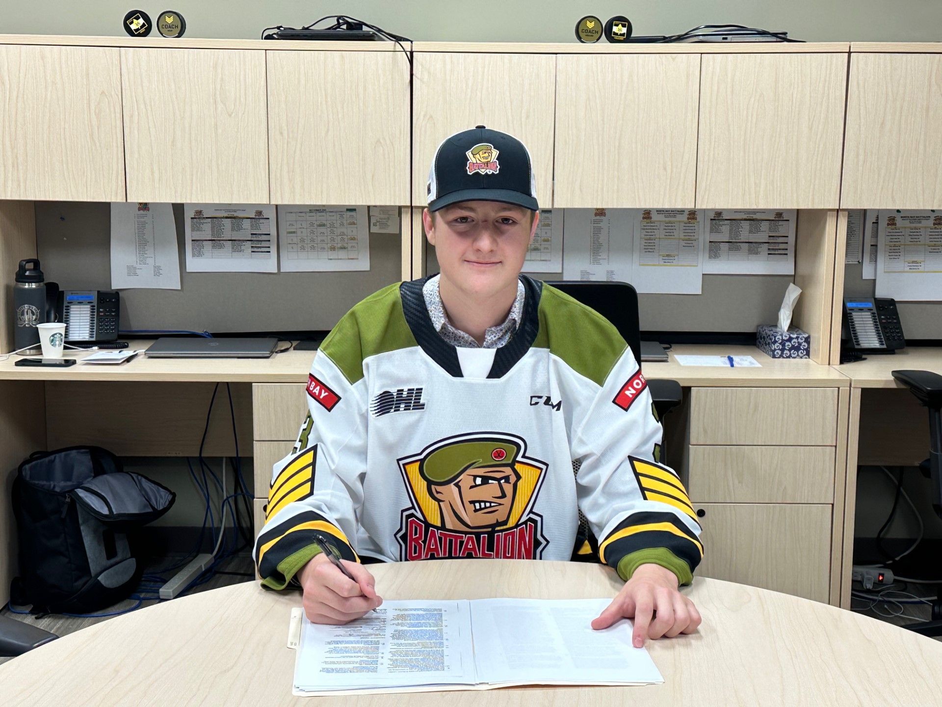 Declan Gallivan signs on the line that is dotted with the Battalion ...