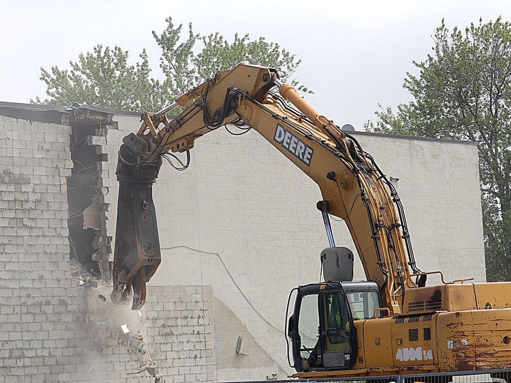 Tearing down blast-damaged buildings paving way for exploratory work ...