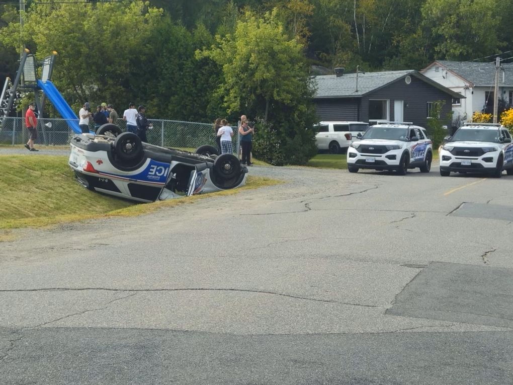 Police officer suffers minor injuries as patrol cruiser flips over ...