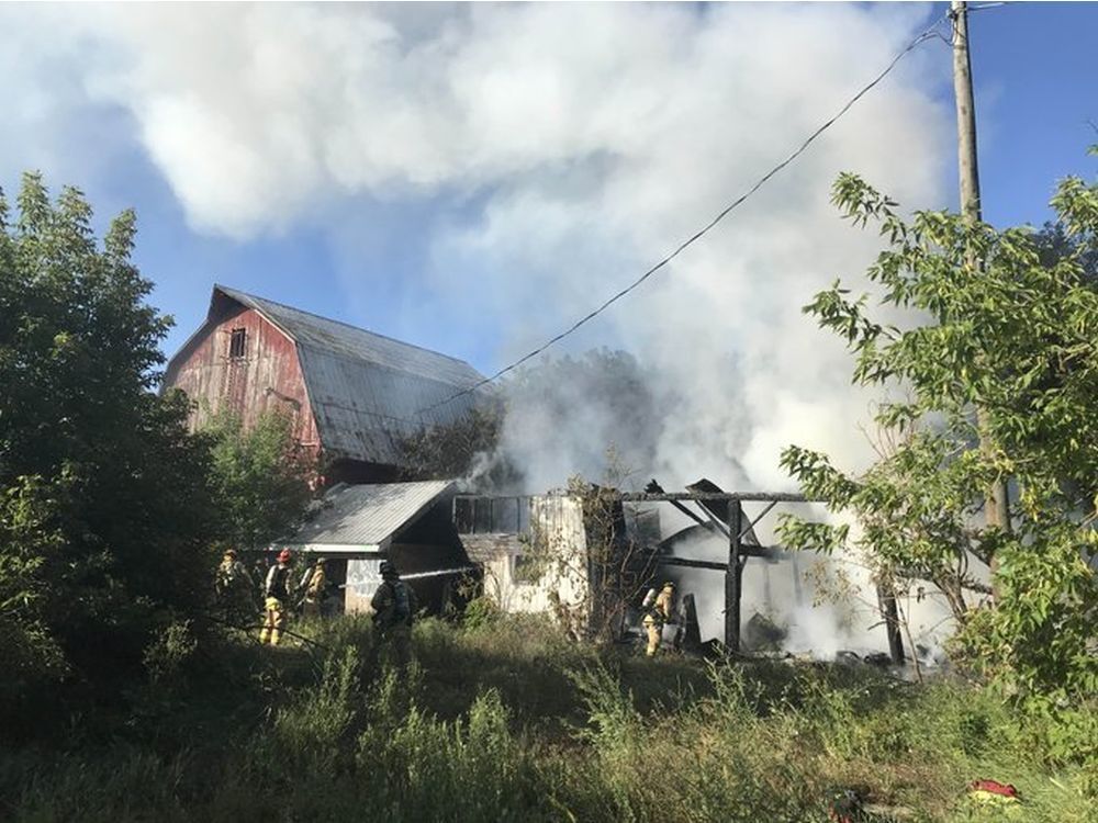 Firefighters escape roof collapse in barn fire on Fallowfield Road ...