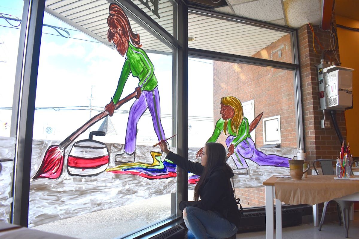 Store windows serving as welcome signs to curling championship ...