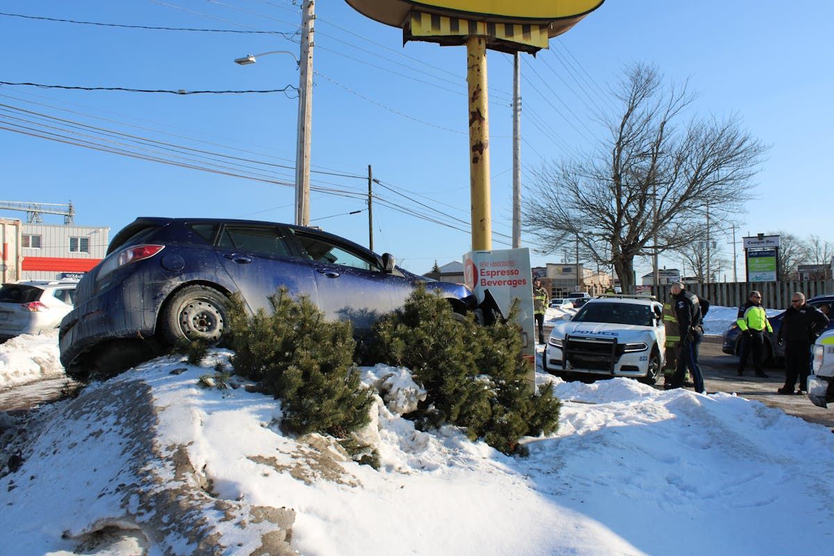 Vehicle crashed into Tim Hortons signpost on busy corner an unusual ...