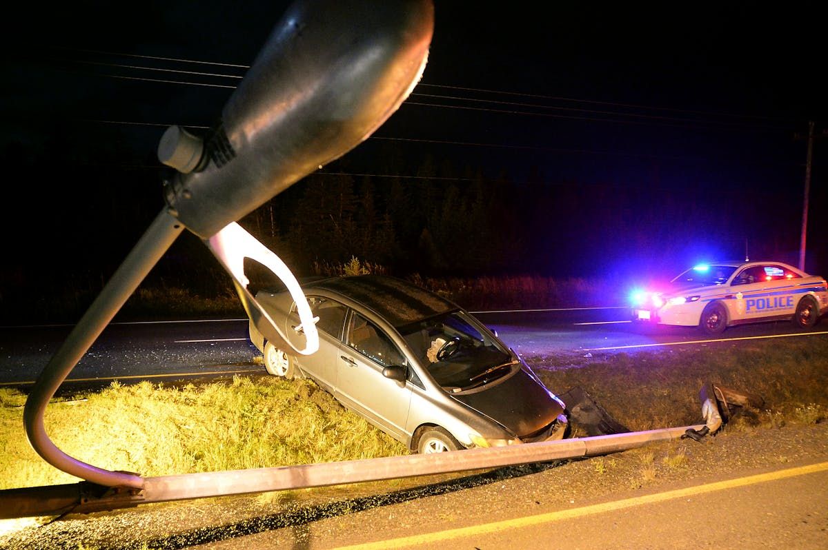Light pole toppled as car crashes into median in early Saturday morning ...