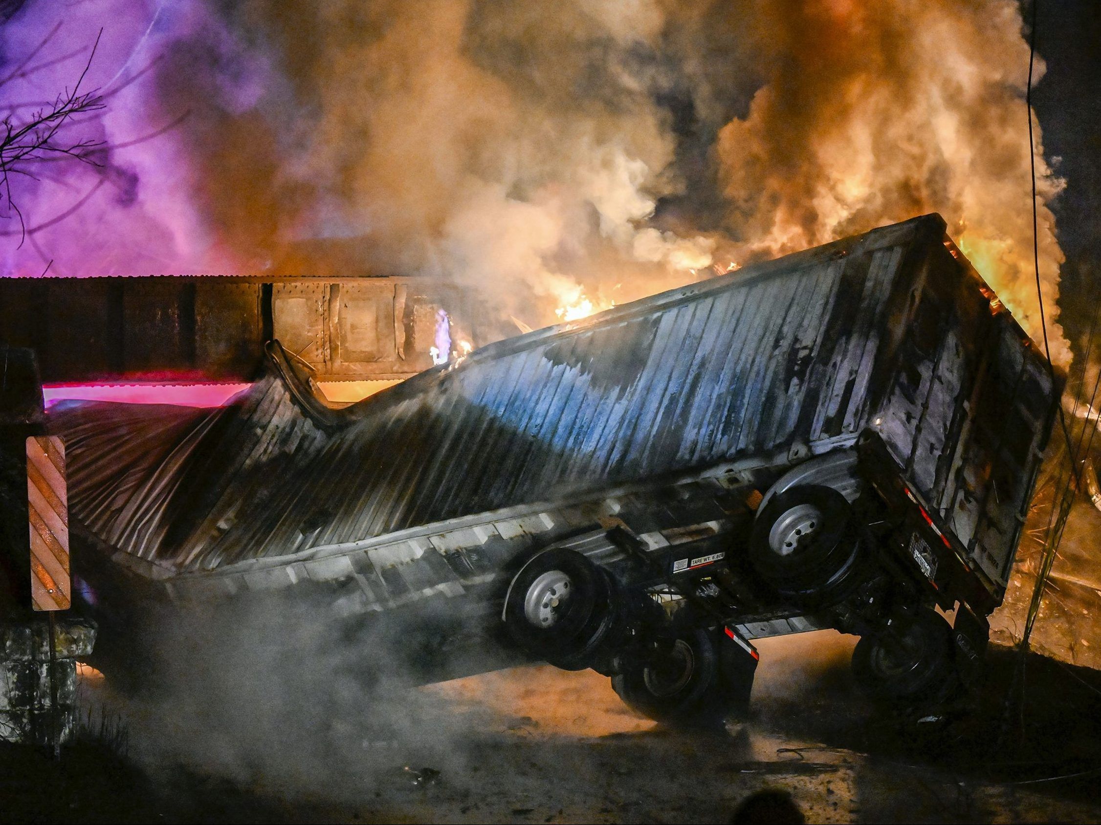 Truck carrying gas hits railroad bridge, explodes as a train passes ...