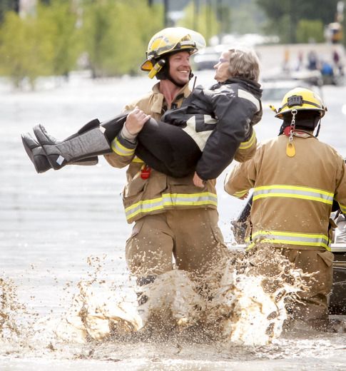 Photogenic firefighter all business working through deadly floods ...