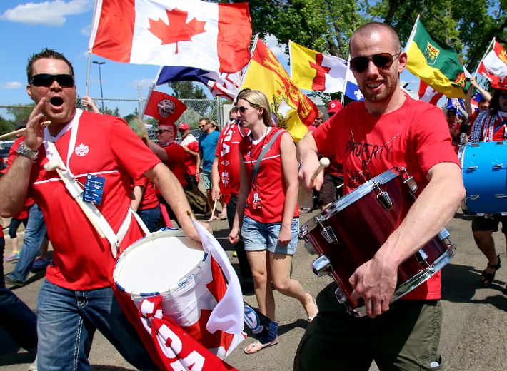 Hundreds of Canada soccer supporters march on the streets of Edmonton ...
