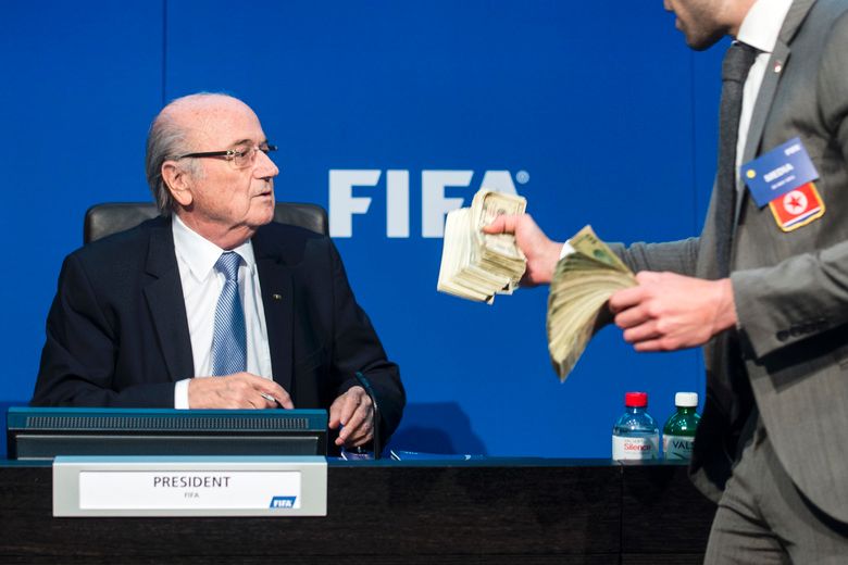 Blatter's news conference delayed by comedian throwing dollar bills at ...