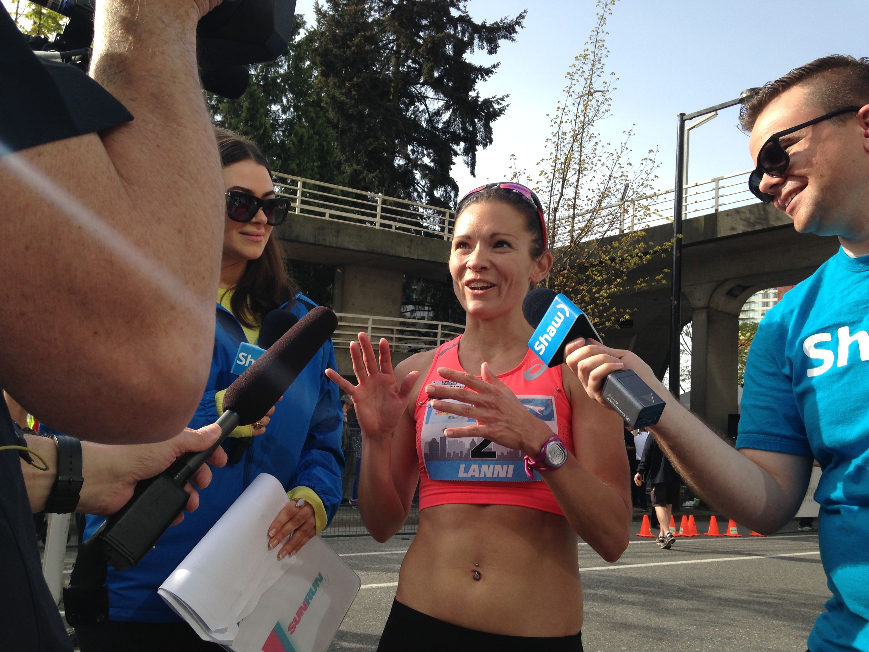 Photos: Sun Run winners Lanni Marchant and Eric Gillis cross the finish ...