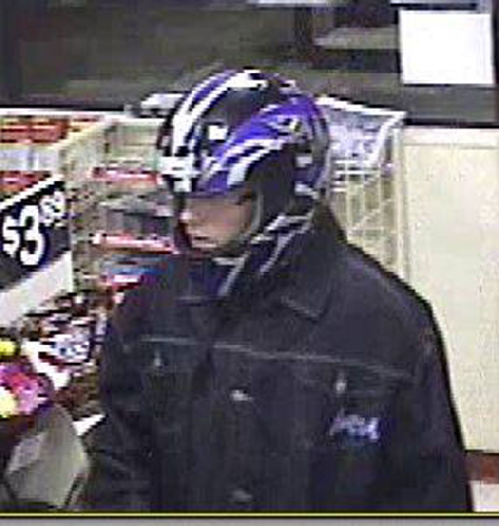 Police release photos of robber who brandished a broken beer bottle ...