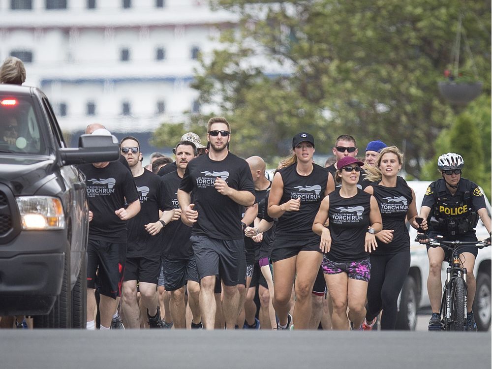 PHOTOS: Law Enforcement Torch Run winds through downtown streets ...
