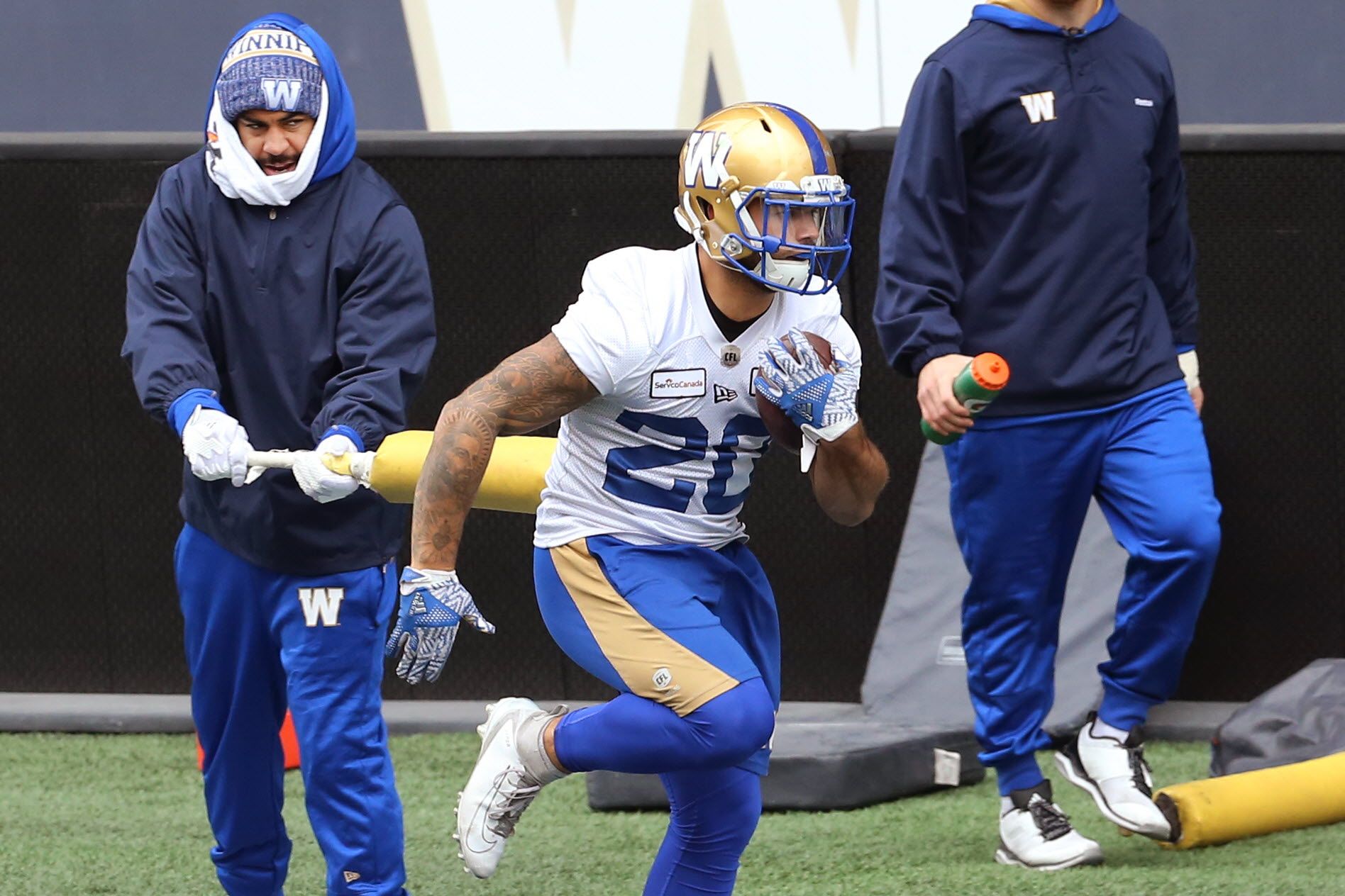 HISTORIC HANDOFF: Appreciative Brady Oliveira takes torch from Andrew Harris in Bombers ...